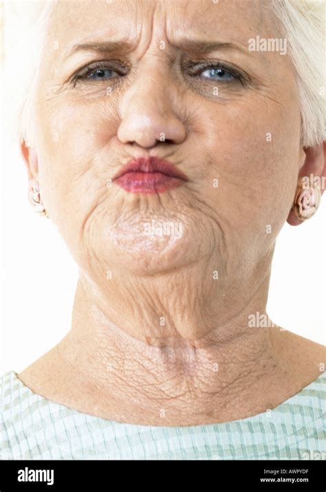 Elderly Woman Puckering Lips And Looking At Camera Portrait Close Up
