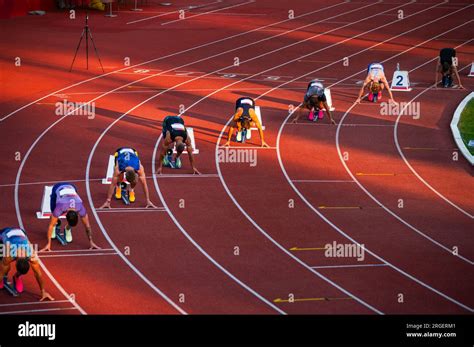 Athletes Positioned At Starting Blocks For The Commencement Of 200m Sprint Race On The Running