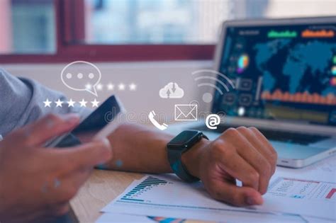 A Man Using A Generic Smartwatch With A Mobile Phone And Computer