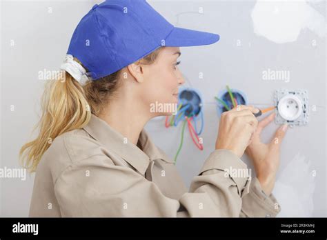 Woman Using Screw Driver During Socket Installation Stock Photo Alamy