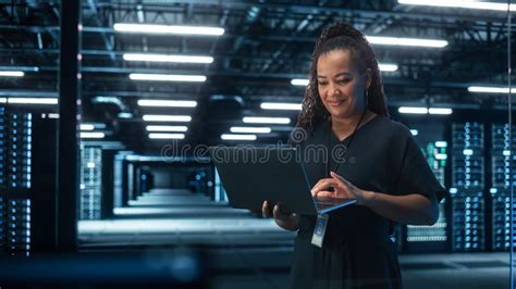 Black Female Chief Technology Office Using Laptop Computer Standing In