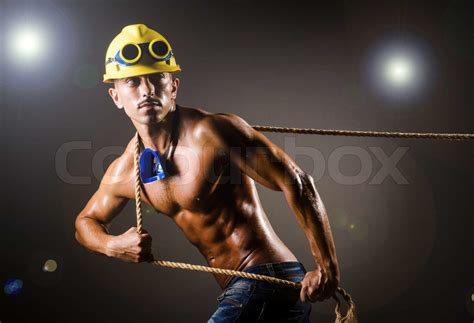 Nude Builder Pulling Rope In Darkness Stock Image Colourbox