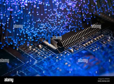 Macro Photograph Of A Printed Circuit Board With A Processor And Optical Fibers Illuminating The