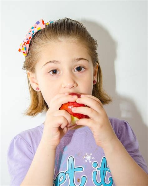 Premium Photo Portrait Of Girl Holding Face Over White Background