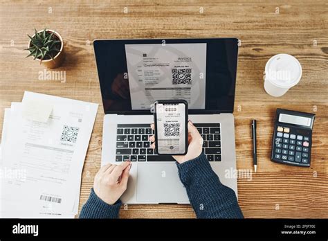 Woman Scanning QR Code From Invoice To Make Payment Using Fast Secure Payment System And