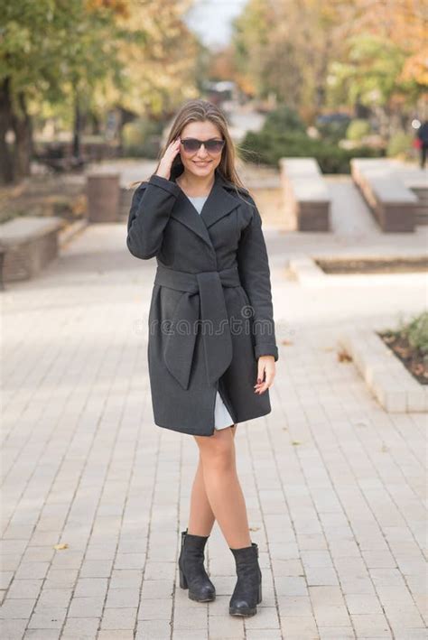 Beautiful And Cute Blonde Girl With Pleasure Posing On The Street