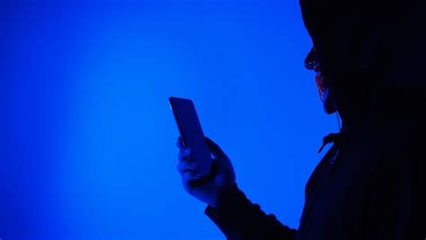 Premium Photo Digital Security Concept Anonymous Hacker With Mask Holding Smartphone Hacked