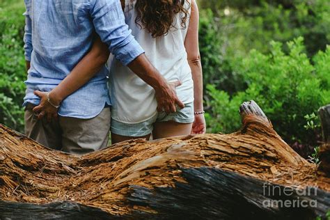 Couple In Love Seen From Behind Holding Each Other And Touching Their