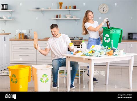 Couple Sorting Garbage At Home Concept Of Recycling Stock Photo Alamy