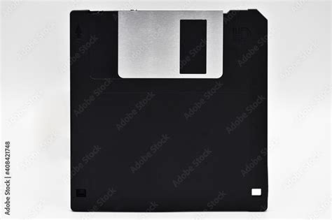 Old computer and data storage technology black magnetic floppy disk ½ inches isolated on