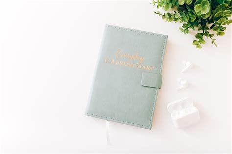 Premium Photo Simple Workspace With Notebook Earphone Plant And Copy Space For Product Display