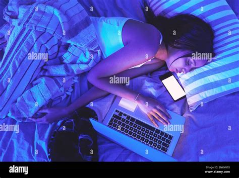Woman Night And Technology While Sleeping In Home Bed With Light From Laptop And Phone In