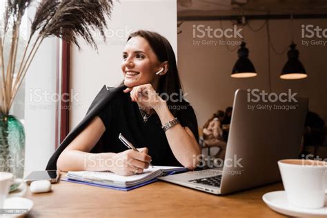 로프트 카페에서 화상 통화를 통해 가족 및 친구들과 채팅하는 행복한 소녀 노트북을 가진 성공적인 비즈니스 여성은 원격으로 일하고 온라인 화상 회의에서 동료들과 웃습니다 25