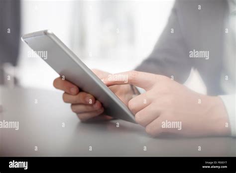 Man Navigating The Internet With His Finger On The Touch Screen Of His Tablet Computer Close Up