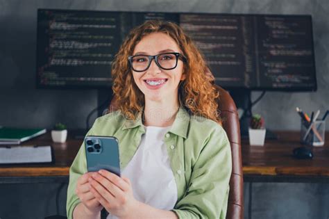 Photo Of Young Hacker Programmer Girl Use Smart Phone Wear Shirt Workstation Loft Office Indoors