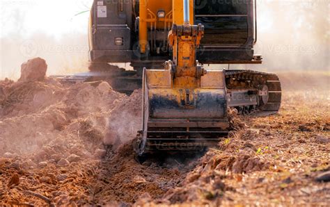 Metal Bucket Of Backhoe Digging Soil Excavator Working At Construction