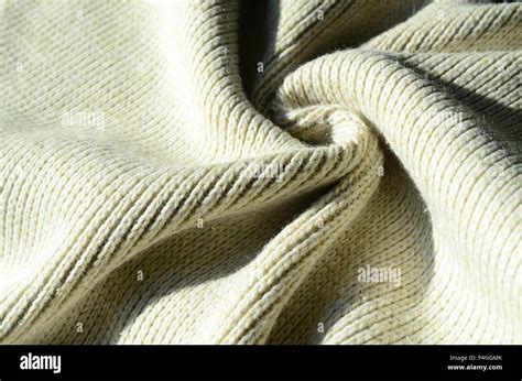Fabric Texture Of A Soft Yellow Knitted Sweater Macro Image Of The