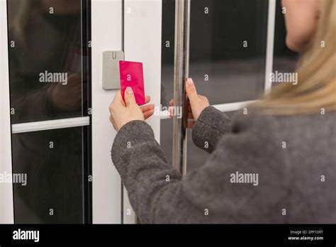 Woman Attaches Card To The Electronic Reader To Access The Apartment Card Entry Personal