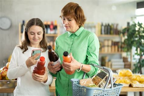 Checking Expiration Date Of Juice Mother And Daughter Checking Qr Code On Bottle Of Juice