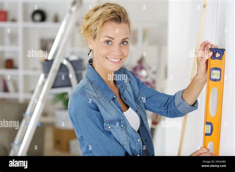 Woman Using Leveling Tool At Home Stock Photo Alamy