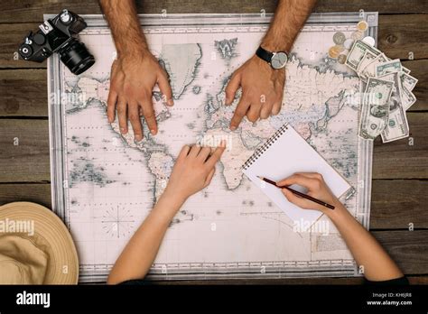 Couple Pointing Place On Map Stock Photo Alamy