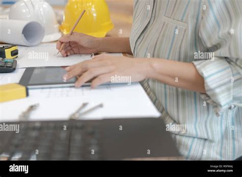 Architect Using Tablet Engineer Working On House Blueprint Of Real Estate Project At Workplace