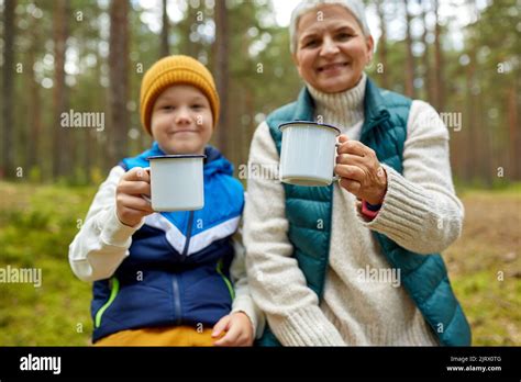 Grandmother With Grandson Drinking Tea In Forest Stock Photo Alamy