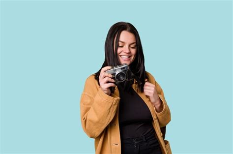 Premium Photo Young Woman Smiling With Film Camera Looking Through