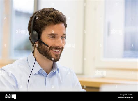 Bearded Man Wearing Headset Using Computer Stock Photo Alamy