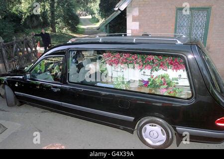 The White Coffin Of Late Tv Presenter Paula Yates Covered In Deep Pink Lilies Is Carried Into