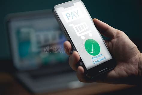 Young Man Using Electronic Payment On Mobile Phone Customer Holding