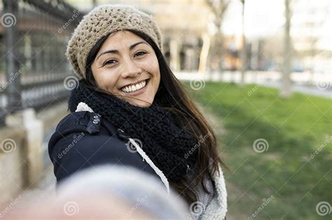 Happy Woman Making A Selfie Showing Two Finger In The City Cheerful