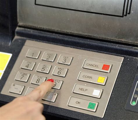 Finger With Red Nail Polish Enters The Top Secret Pin Code Into The