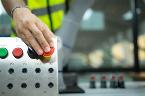 Premium Photo Closeup Of Hand Pressing The Stop Button On The Control