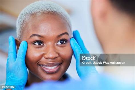 의료용 손 여성 및 화장품 성형 수술 미적 및 얼굴 변형을 검사합니다 행복한 아프리카 환자 또는 고객 얼굴 검사 피부과 도움 및 지원을 제공하는 의사 또는 외과 의사 성형