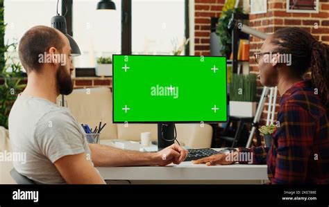 Diverse People Working With Greenscreen Monitor On Computer Analyzing
