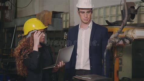 Engineer Man And Diverse Female Factory Workers Talking And Present Or Explain Robot Welding