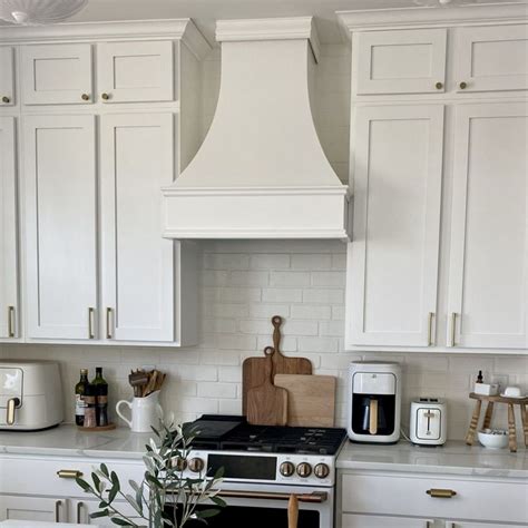 White Wood Range Hood With Curved Front And Decorative Trim 30 36 42