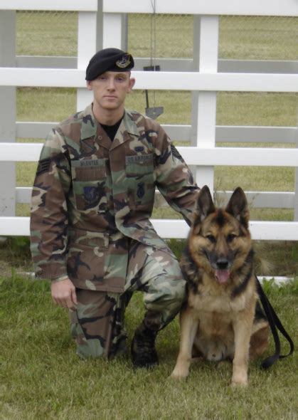 Sergeant Timothy Mcentee Poses For A Photo With The Newly Adopted Dog