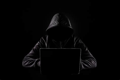 premium photo hacking and technology crime concept no face hacker with laptop over programming