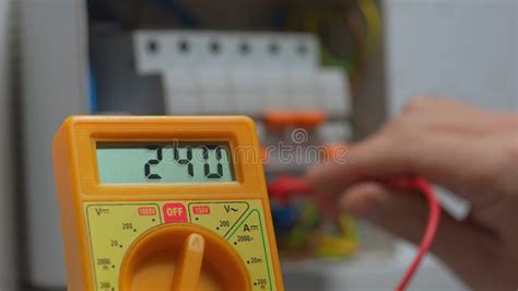 Yellow Multimeter For Measuring Voltage Close Up Work Under Voltage Electrician Is Checking