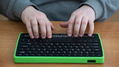 A Blind Man Uses A Computer With A Braille Display And A Computer Keyboard Inclusive Device