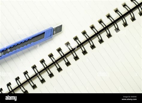 Cutter On Notebook Background Texture Stock Photo Alamy