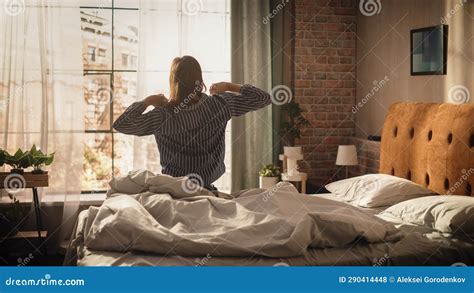 Beautiful Young Woman Waking Up In The Morning Stretches And Gets Out
