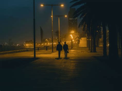 Woman Walking Down The Street At Night