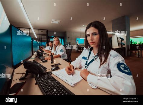 Group Of Female Security Operators Working In A Data System Control Room Technical Operators