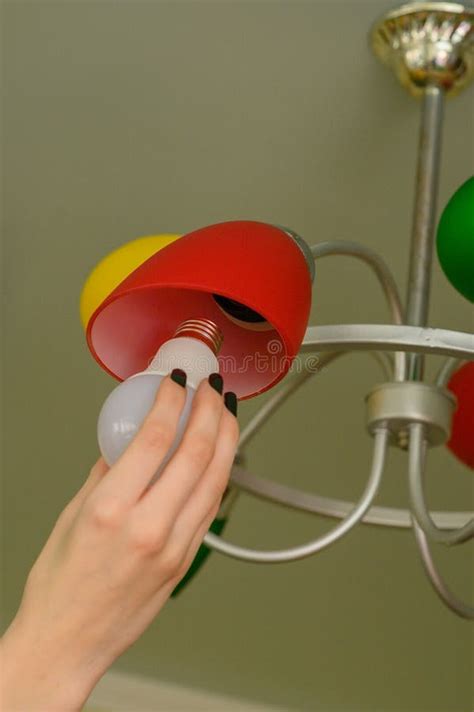 replacing the led light bulb in the lamp stock image image of repairs