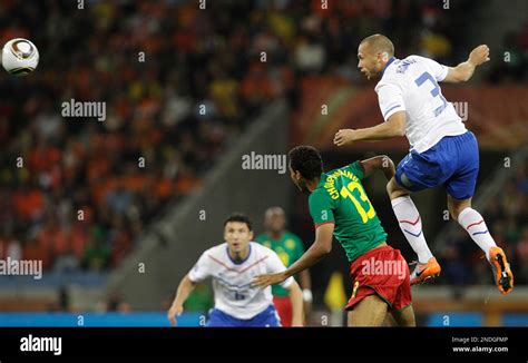 netherlands john heitinga right cameroon s eric choupo moting second from right during the