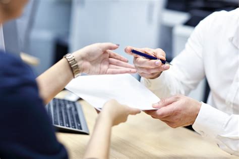 Premium Photo Adult Hands Holding Documents And Pen