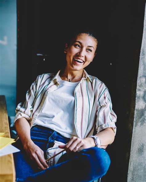 Cheerful Chinese Hipster Girl Has Break During Work At Netbook Stock